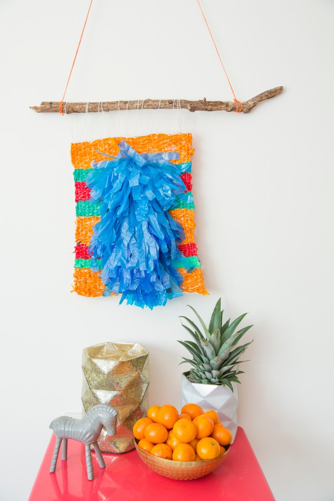 Another use for old plastic bags, weave a wall hanging